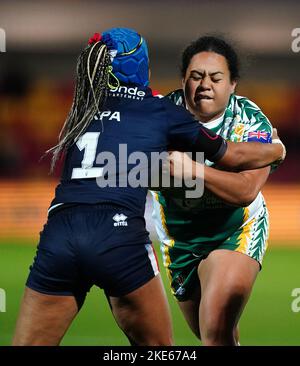Cook Islands' Kennedy Harrison-Vahua (centre) tackled by France's Elisa ...