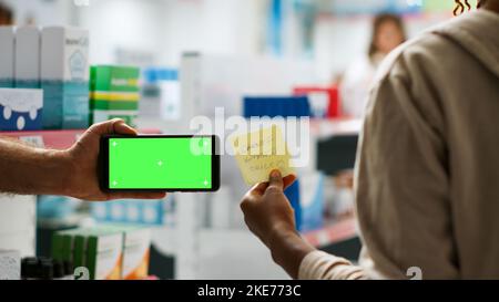 Smartphone showing horizontal greenscreen template in pharmaceutical ...