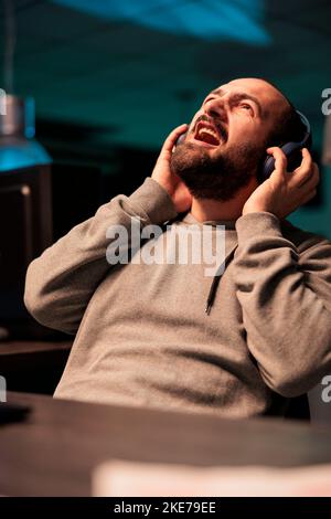 Funny programmer screaming and listening to music on headset, working ...
