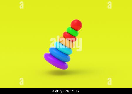 Toy pyramid tower on yellow background. Children education. Educational ...