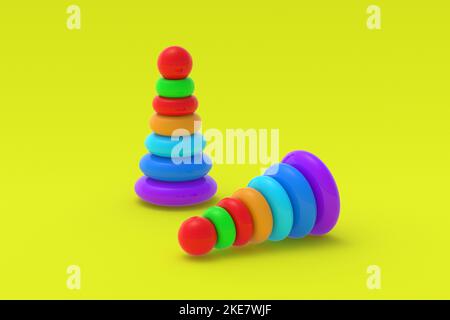 Toy pyramid towers on yellow background. Children education ...