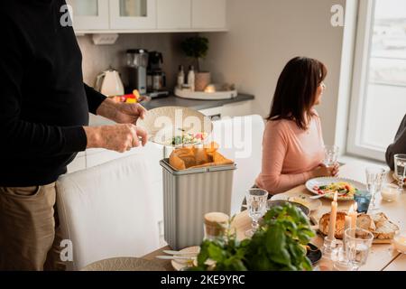 Family cleaning after having dinner Stock Photo - Alamy
