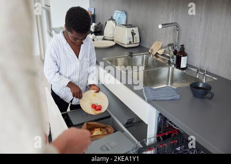 Boy throwing out leftover food Stock Photo - Alamy