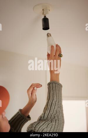 human hand changing a light bulb Stock Photo - Alamy