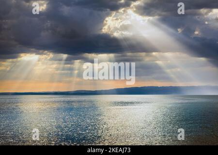 Tyndall effect over Lake Constance, sun rays break through cloudy sky ...