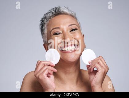 Cotton pad, skincare and senior woman in studio for beauty, cleaning ...