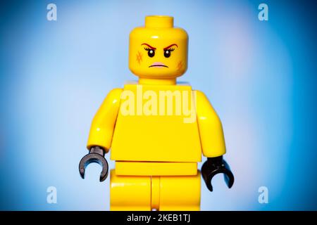yellow lego figure with an evil face on a blue background. High quality ...