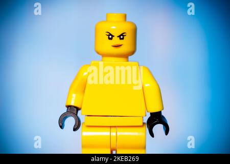 yellow lego figure with an evil face on a blue background. High quality ...