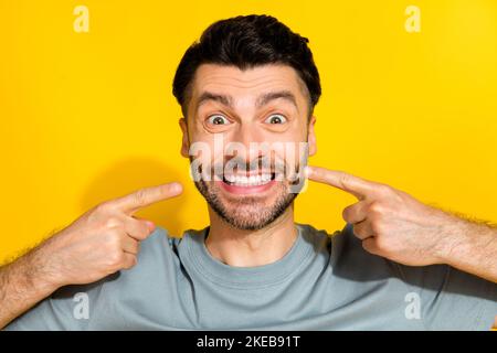 Photo of funny positive toothy beaming guy wear santa claus hat with ...