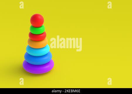 Toy pyramid tower on yellow background. Children education. Educational ...