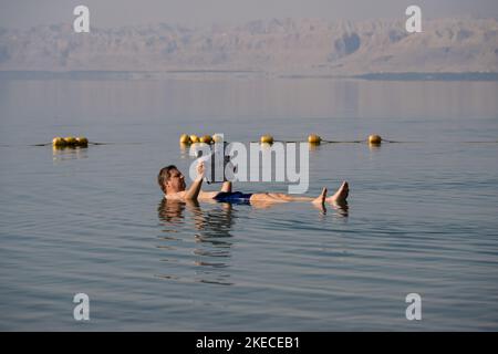 Man floating at Dead Sea Jordan Stock Photo - Alamy