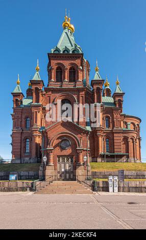 The facade of the Helsinki Cathedral against a blue sky on a sunny day ...