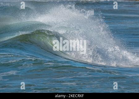 Ferocious Mediterranean waves crash onto the beach in the summertime ...