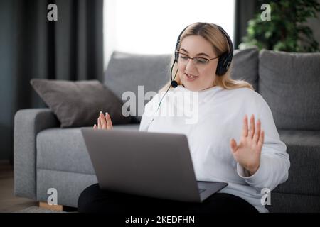 Student in headset using laptop Stock Photo - Alamy
