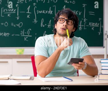 Young male student mathematician in front of chalkboard Stock Photo - Alamy