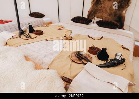 The interior of a rustic-style tent with hunting equipment and ...
