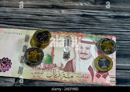 Pile of 1 one Saudi Arabia riyal coin currency features king Salman on ...
