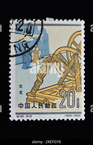 CHINA- CIRCA 1962. A stamp printed in China depicting traditional wear ...