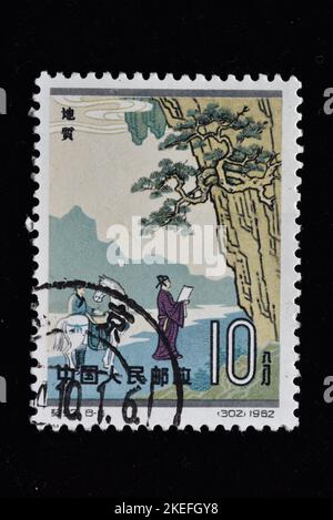 CHINA- CIRCA 1962. A stamp printed in China depicting traditional wear ...