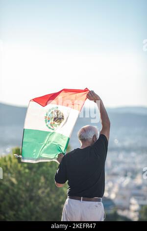 Senior man holding flag of Mexico. "September 16. Independence Day of ...