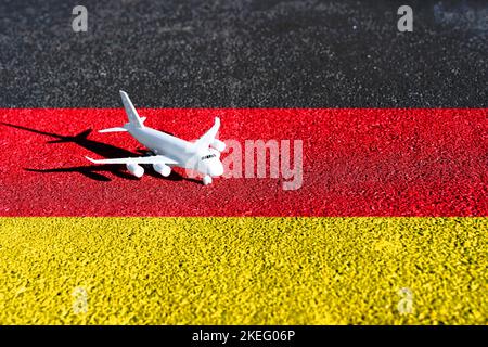 Toy airplane placed on the road painted the colors of the national flag ...