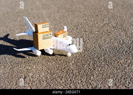 Toy airplane and tiny delivery boxes placed on the sidewalk Stock Photo ...