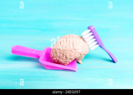 Human brain, toy dust pan and brush on blue background. Creative mind ...