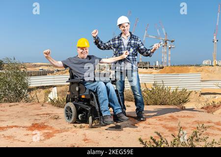 Two professional builders standing with a computer in front of the ...