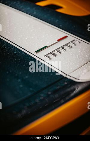 A closeup shot of the back end of a Ferrari 458 Speciale after rain ...