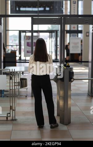 Security personnel checking bags and backpacks x-rayed at the access ...