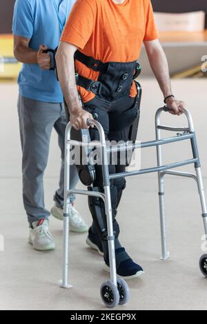 Boy with Mobility Problems in Lower Limbs in Upright Posture Walking ...