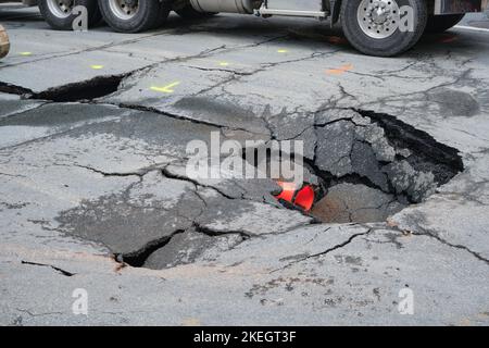 Sink hole in middle of asphalt street following collapse of road Stock ...