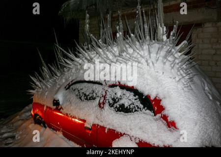The car under snow is stuck with large icicles, winter: Russia ...
