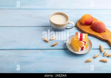 Almond milk and peach jelly on gray concrete background. side view ...