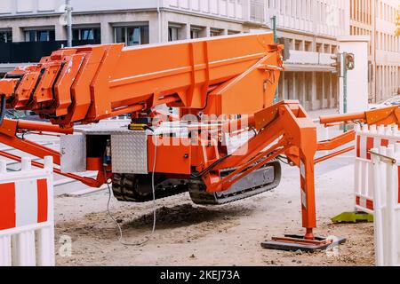 Industrial telescopic unmanned crane standing on hydraulic support legs ...