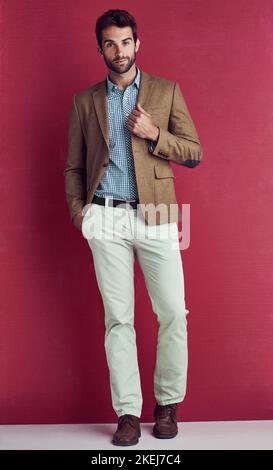 On that style grind. Studio shot a handsome and stylishly dressed young ...