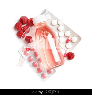 Cough syrup with spoon, raspberries and pills for sore throat on beige ...