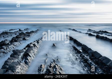 Stunning sunset landscape image of Welcome Mouth Beach in Devon England ...