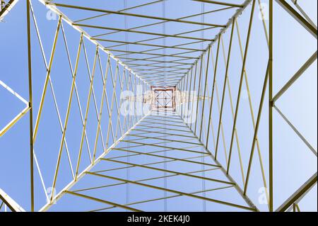 Electric pylon in perspective seen below with light blue background ...