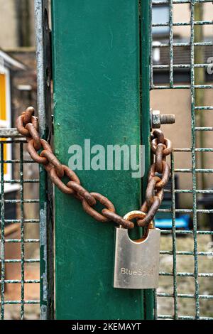 Chain link fence gates chained and locked with no trespassing, private ...