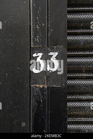 Metal shop front shutter with number 33 Stock Photo - Alamy