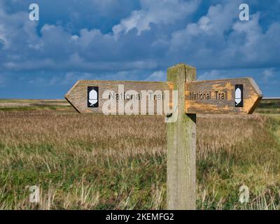 A weathered wooden fingerpost points the way on the North Norfolk Coast ...