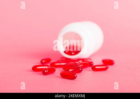 Red pills spilled around a pill bottle. Medicines and prescription ...