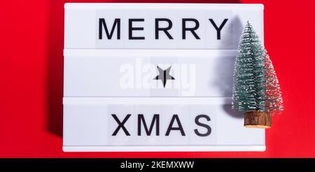Merry Christmas greetings on lightbox on red with american flag Stock ...