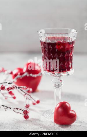 Red cocktail, vodka or liqueur and Heart shape decorations Stock Photo ...