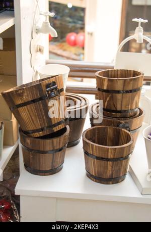 Set of buckets made of wood in a market place Stock Photo - Alamy