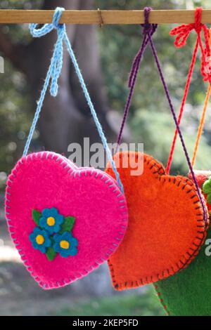 Heart shaped colorful hand bags for women outdoors Stock Photo - Alamy