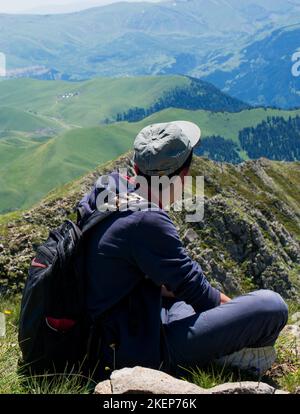 Young man taking an excursion on a mountain Stock Photo - Alamy