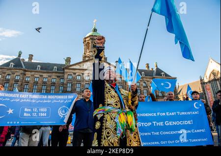 An Uyghur man is seen raising the Uyghur flag in the middle of the ...