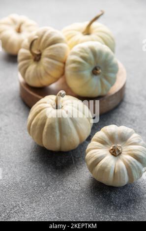 Thanksgiving season still life with small pumpkins and fall leaves over ...